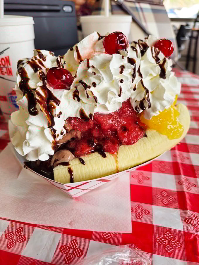 Not just a banana split—it's a architectural marvel of dairy engineering topped with enough whipped cream to make a cloud jealous.
