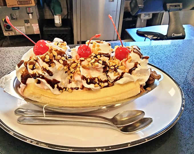 This banana split isn't just dessert; it's architecture with a cherry on top and enough whipped cream to make your diet cry uncle.