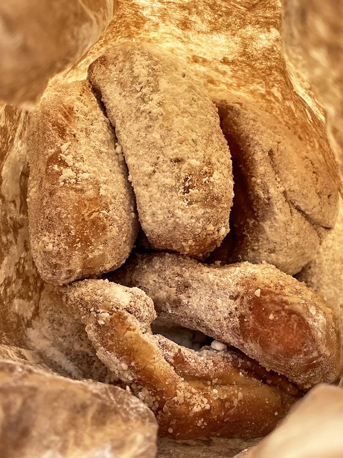 These sugar-dusted beignets aren't just pastries—they're little pouches of joy that crackle with each bite, releasing their cinnamon secrets.