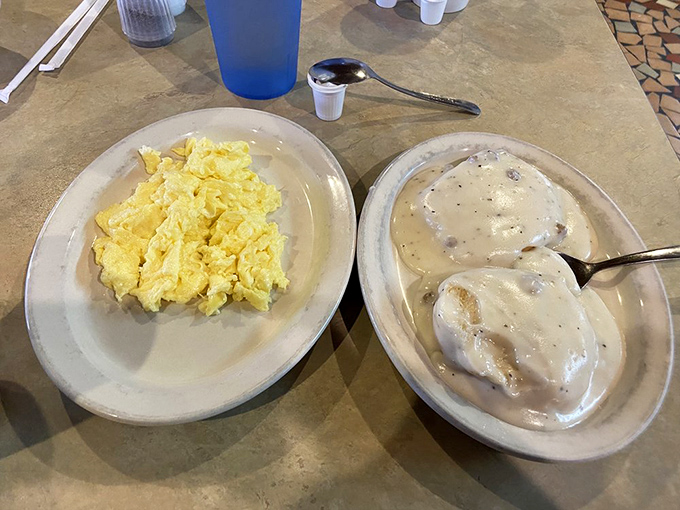 Biscuits and gravy alongside scrambled eggs—the breakfast equivalent of a warm blanket on a chilly morning. Nap scheduling recommended.