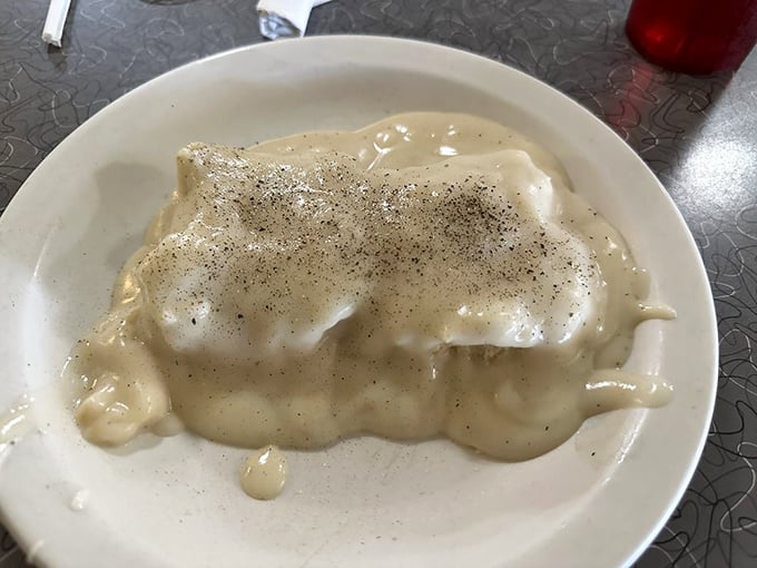 Biscuits and gravy—the breakfast equivalent of a warm hug, with pepper-speckled country gravy cascading over freshly baked goodness.