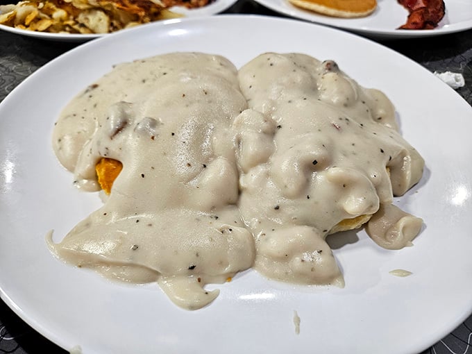 Biscuits swimming in creamy, peppery gravy – the kind of Southern comfort that makes you want to hug the chef afterward.
