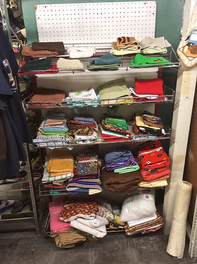 Linens and textiles stacked with surprising precision – each folded blanket holding stories of past comfort, ready for new chapters in different homes.