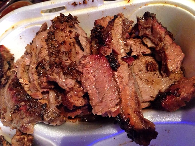 Brisket with that telltale pink smoke ring—visual evidence of the low-and-slow philosophy that separates the great from the good.