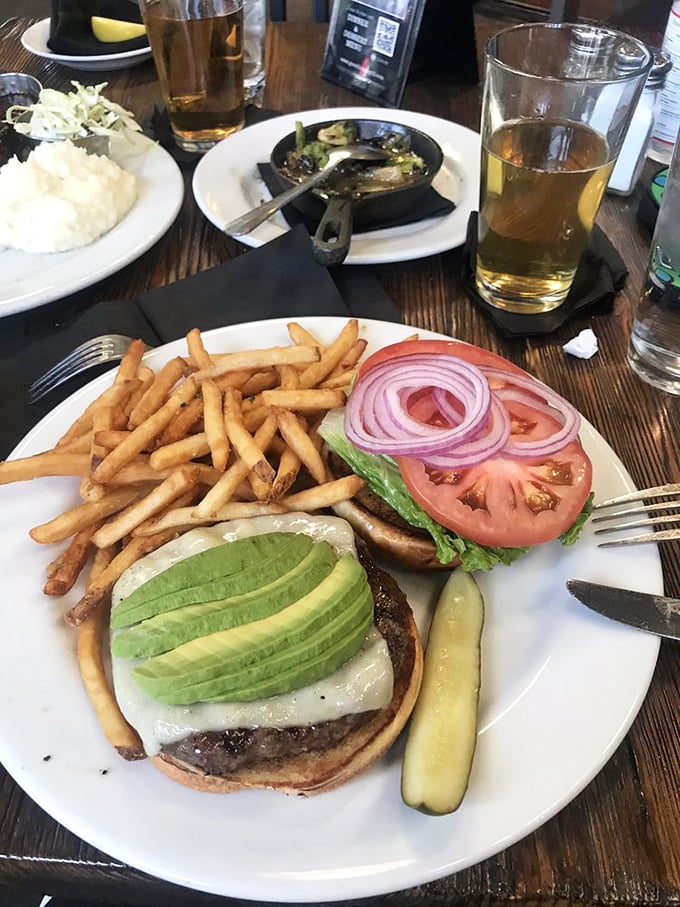 Behold: the burger that launched a thousand road trips. Perfectly stacked with avocado slices fanned out like a hand of winning cards.