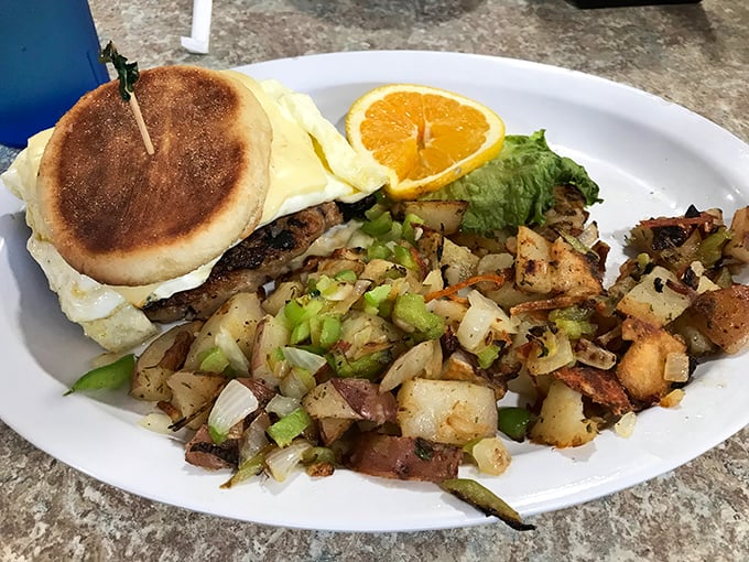 This breakfast sandwich with a side of home fries isn't trying to impress food critics—it's trying to cure what ails you, one hearty bite at a time.