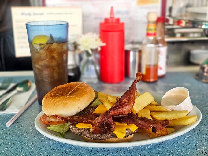 The classic American cheeseburger with bacon: solving life's problems one perfectly crispy strip at a time.
