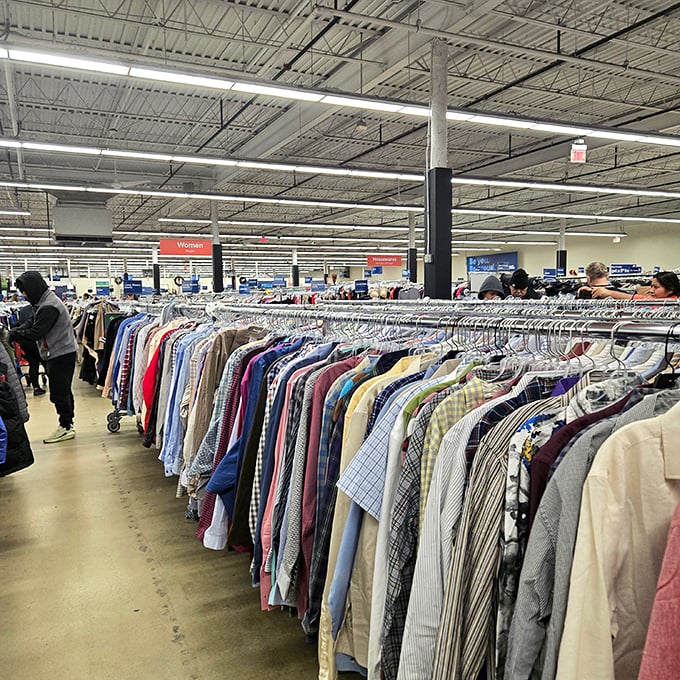 Clothing racks stretch to the horizon like textile soldiers standing at attention, each garment hoping you'll be its second chance.
