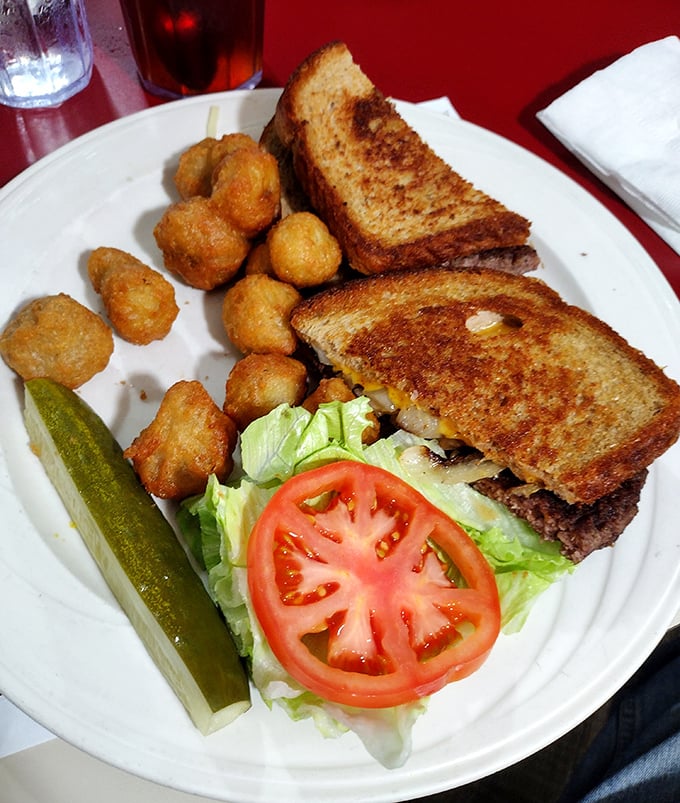 A classic diner patty melt with tater tots—proof that sometimes the simplest combinations create the most profound happiness on a plate.