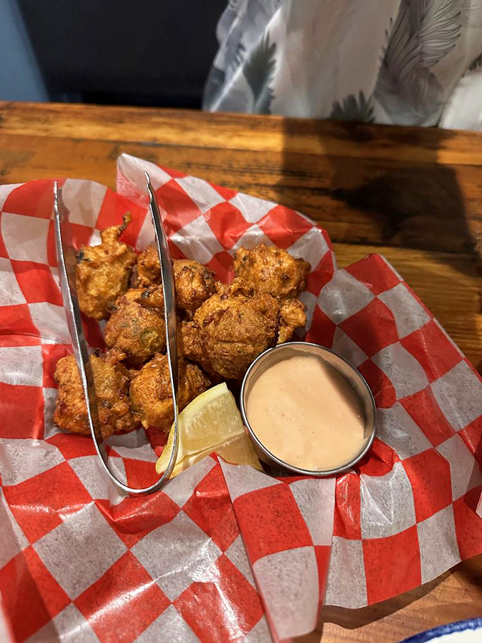 Golden-fried conch fritters with dipping sauce—little spheres of happiness that transport you straight to a Key West sunset without the sunburn.