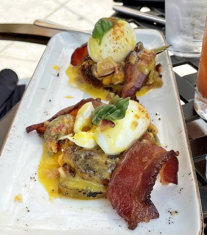 Breakfast meets art form with these Benedict creations—where perfectly poached eggs perform a golden lava flow over crispy bacon.