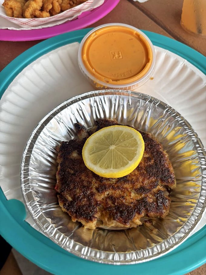 The famous crab cake – more crab than cake – sits proudly with its golden-brown crust, practically begging you to discover its sweet, tender interior.