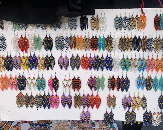 A hypnotic display of handcrafted earrings that would make Elizabeth Taylor pause mid-sentence—each pair telling its own colorful story.