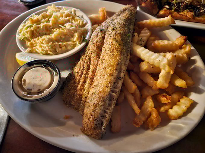 This fish fillet isn't just dinner—it's a golden-crusted masterpiece accompanied by the kind of fries that disappear one "just one more" at a time.