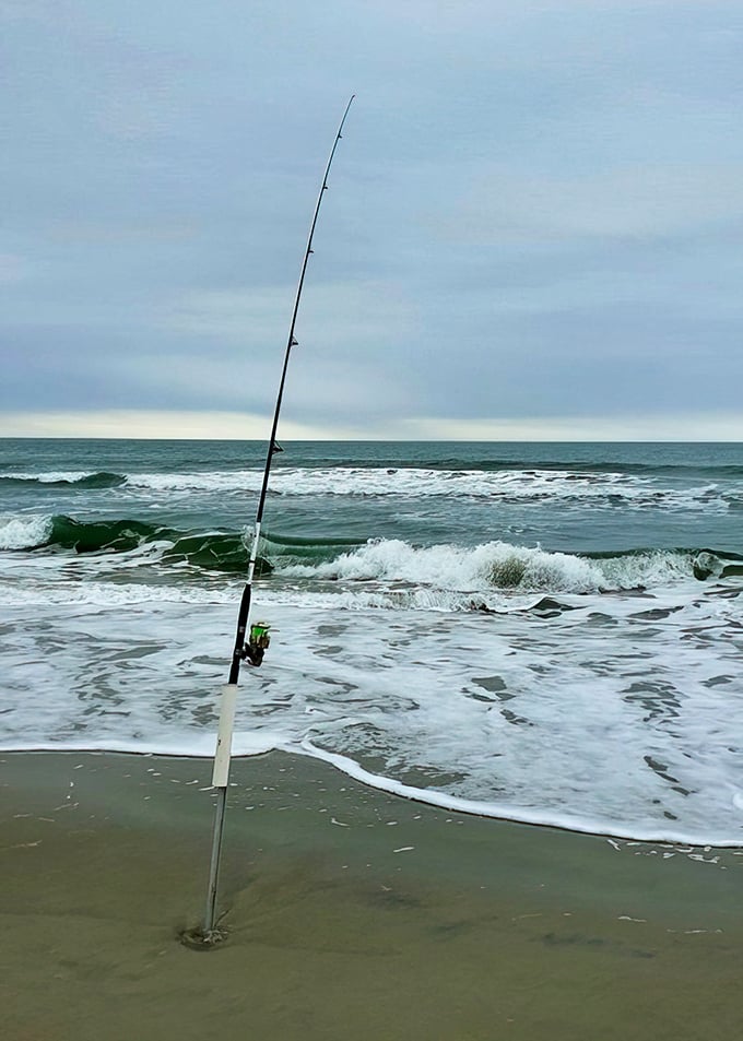 Patience cast into the surf. There's something zen-like about a fishing rod standing sentinel against the rhythm of incoming waves.