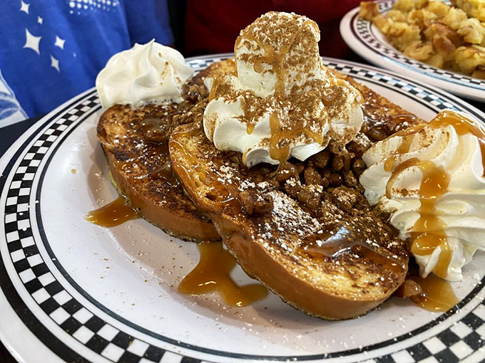 French toast that's having an identity crisis as a dessert – topped with whipped cream, caramel, and enough decadence to require a post-meal confession.