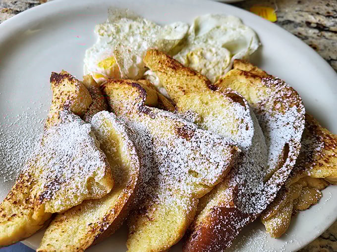 French toast that's achieved the golden ratio: crispy edges, custardy centers, and enough powdered sugar to make your dentist wince with delight.