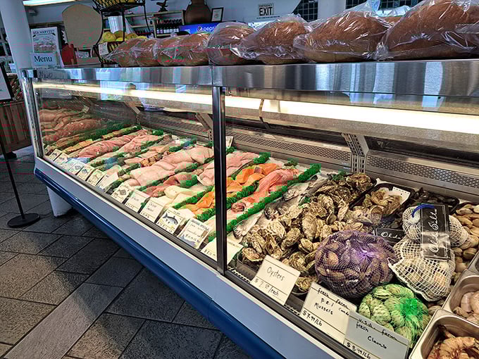 The fish market display case—where relationships between fishmongers and home cooks begin. These glistening fillets and shellfish haven't been on a first-name basis with freezers.