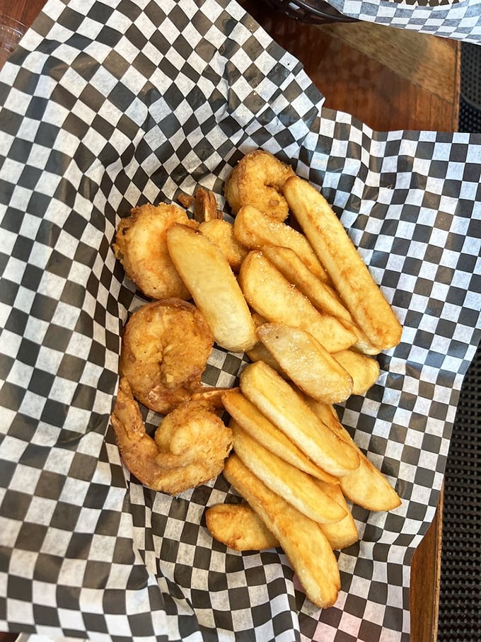 Golden-fried shrimp nestled among crispy fries – the kind of basket that makes you wonder why you ever eat anything else when near the ocean.