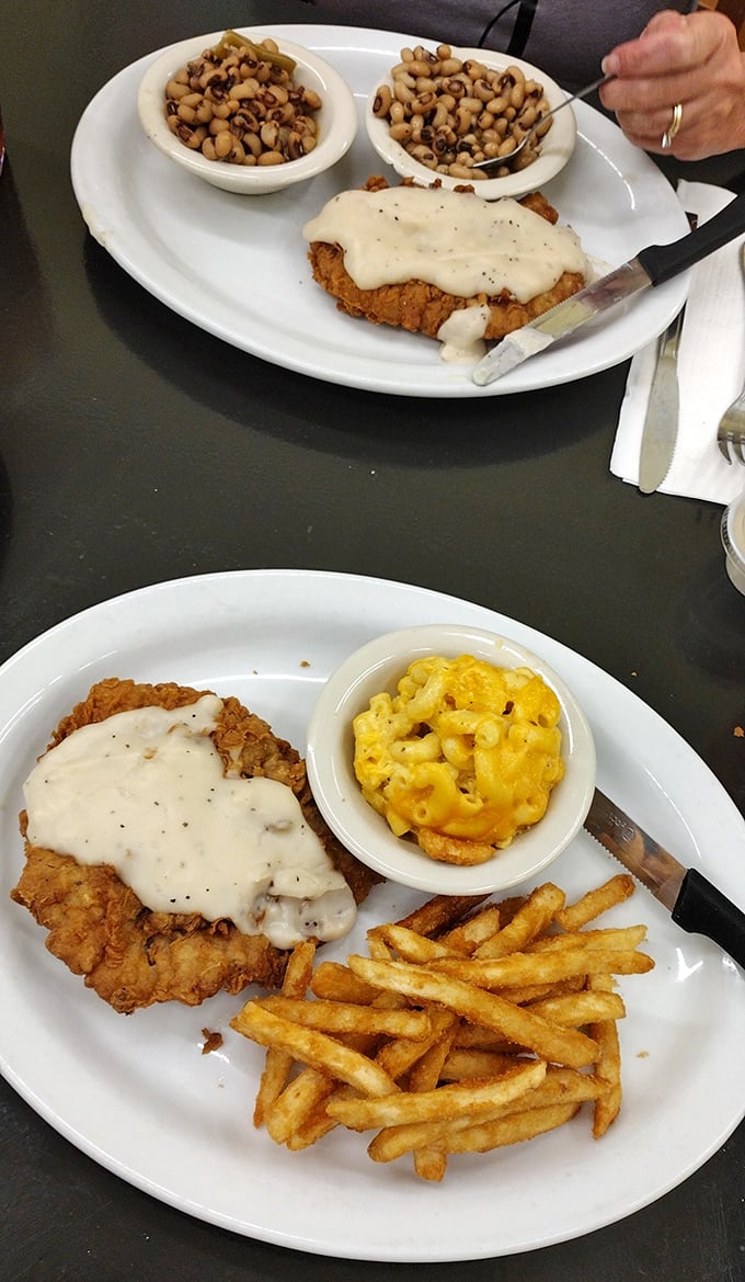 Country fried steak with gravy, mac and cheese, and crispy fries – the triumvirate of comfort food that makes cardiologists wince and taste buds sing hallelujah.