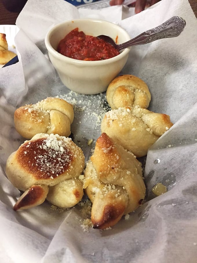 Garlic knots that could make a vampire reconsider their life choices. Dusted with parmesan and served with marinara, they're the perfect pizza prelude.