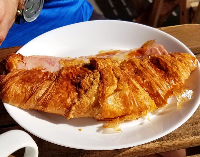 This ham and cheese croissant isn't just breakfast—it's butter architecture, with layers so flaky they practically whisper "bonjour" with each bite.