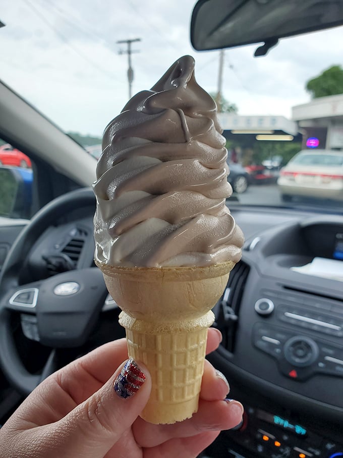 Soft-serve swirled to gravity-defying heights. This chocolate cone isn't just dessert—it's an architectural achievement you can eat. 