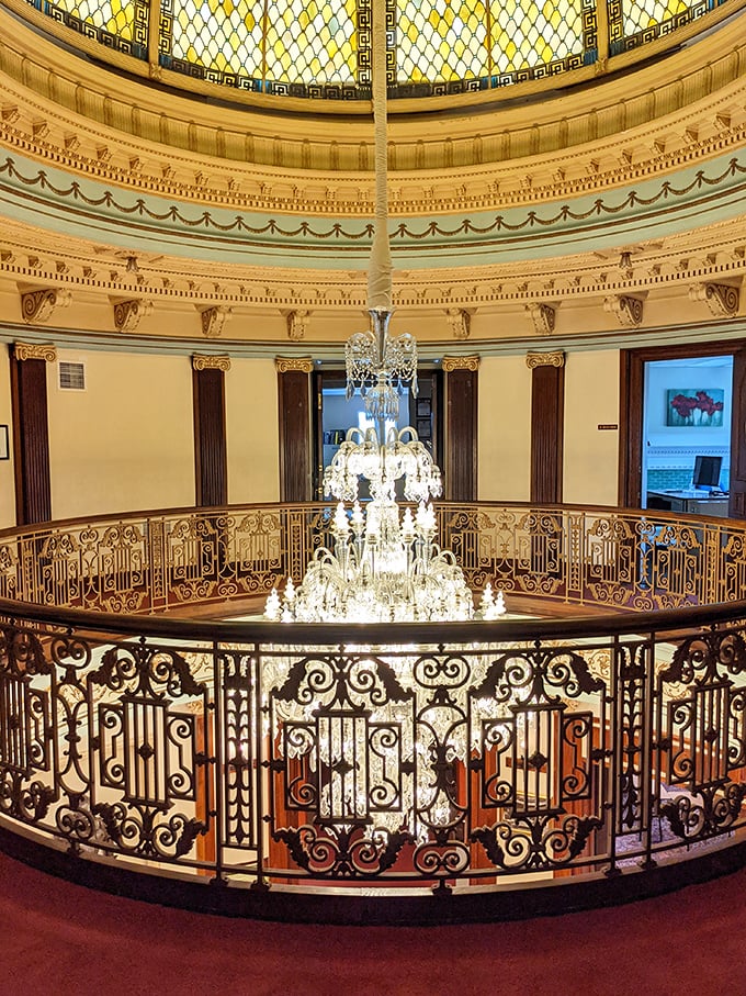Intricate ironwork and gleaming wood create a circular gallery where every step feels like you're walking through the pages of architectural history.