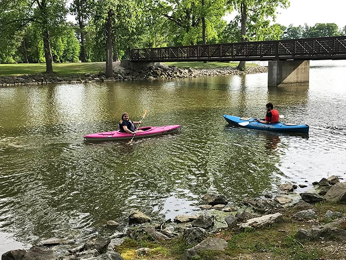Kayaking under the bridge—where "getting away from it all" meets "having the time of your life" in colorful watercraft.