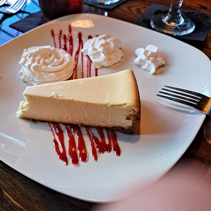 This isn't just key lime pie, it's a New York-style slice of heaven adorned with raspberry sauce and whipped cream—proof that Florida knows how to honor the classics.