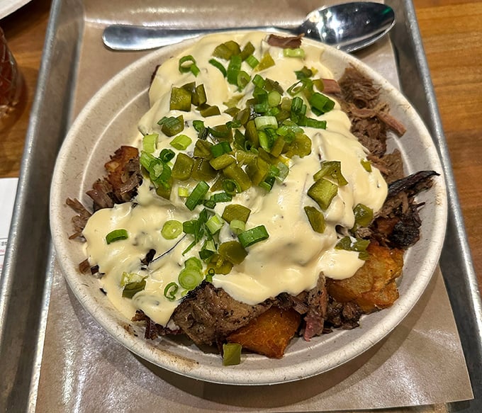 Loaded fried potatoes topped with brisket and cheese sauce—because sometimes your comfort food needs its own comfort food.