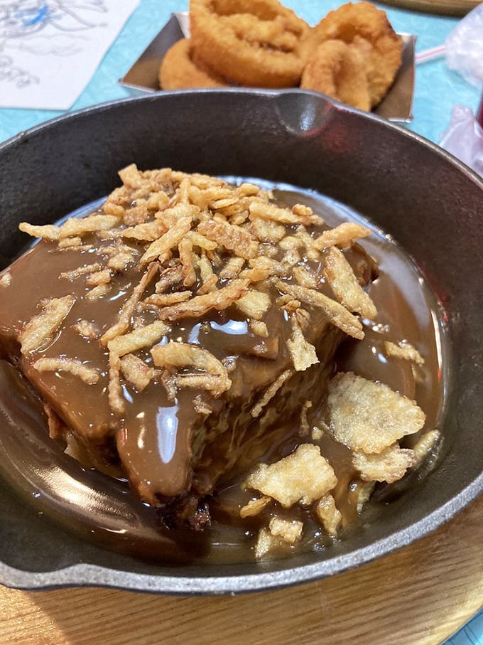 This isn't just meatloaf—it's a warm hug served in cast iron, topped with crispy onions that add the perfect textural counterpoint to that rich gravy.