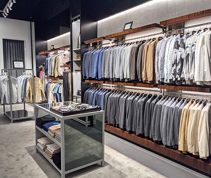 The men's department: where rows of blazers and dress shirts stand at attention, waiting to transform desert wanderers into boardroom commanders.
