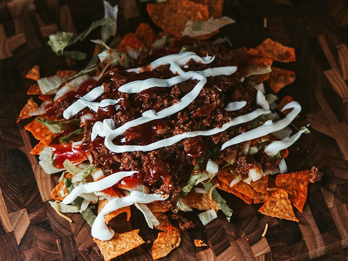 Taco salad that throws moderation to the wind—a glorious mess of seasoned beef, crisp lettuce, and cool sour cream that makes every bite a fiesta.