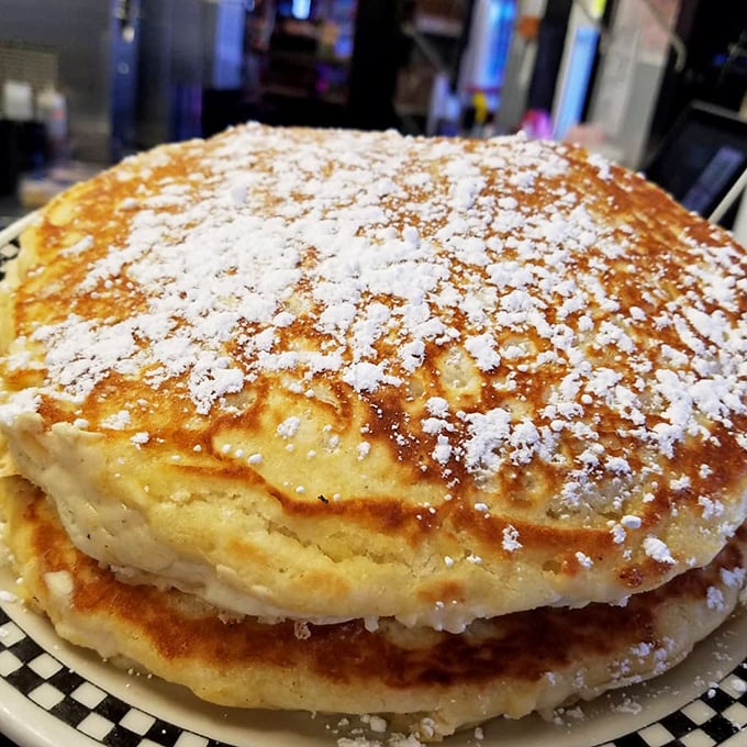 Pancakes so fluffy they could double as pillows. Dusted with powdered sugar and large enough to require their own zip code.