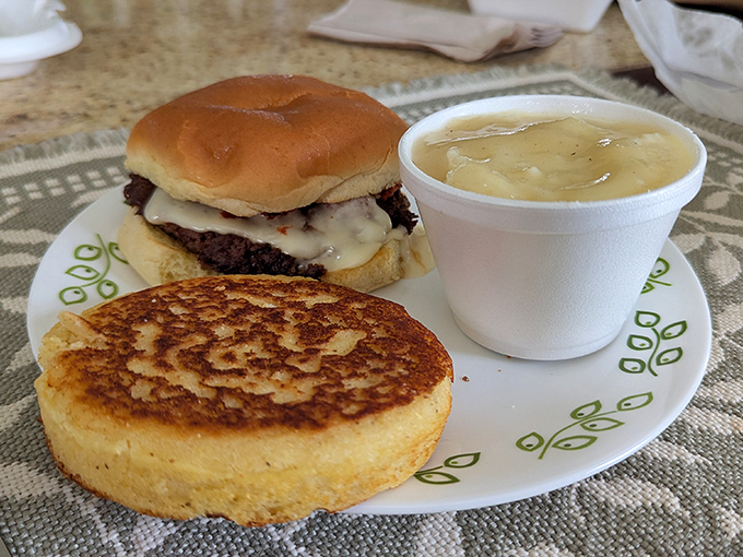 Comfort food trifecta: a golden-brown pancake with crispy edges, a juicy burger on a soft bun, and a cup of homestyle soup that warms you from the inside out.