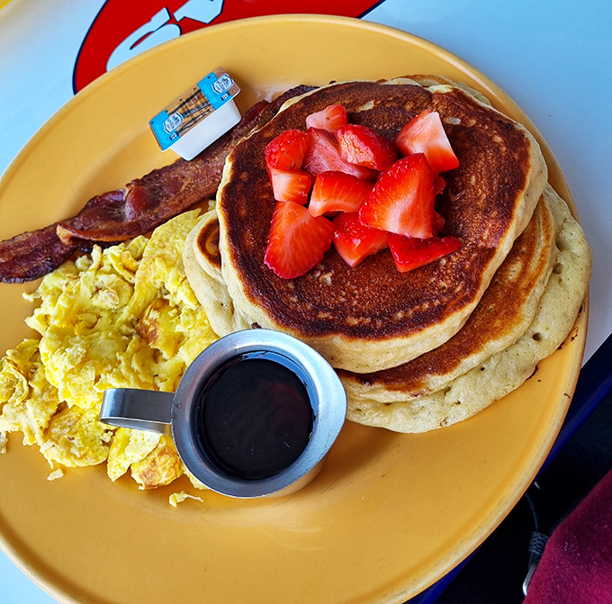 Golden pancakes with fresh strawberries – the breakfast equivalent of getting an unexpected tax refund and finding a parking spot simultaneously.