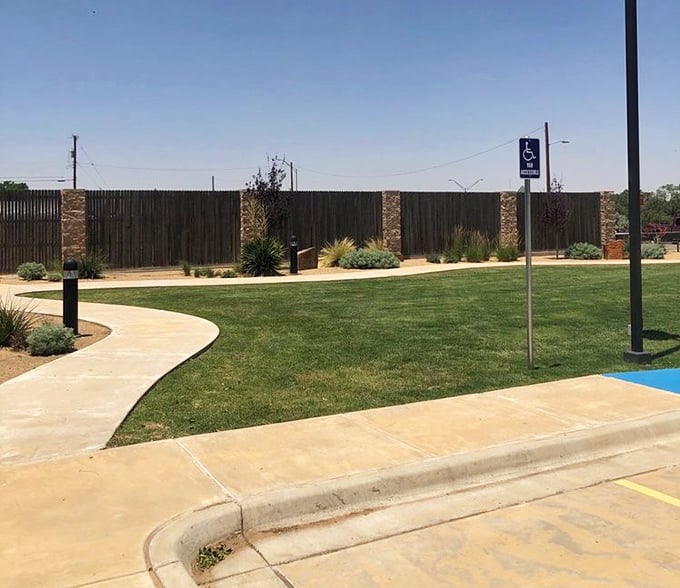 The beautifully landscaped park area provides the perfect setting for family photos with America's most photogenic concrete cowboy standing guard.