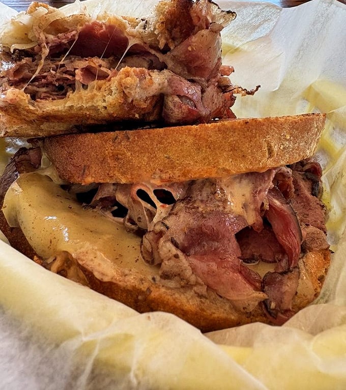 This isn't just a sandwich; it's a pastrami skyscraper with serious meat credentials. The kind of sandwich that demands both hands and your full attention.