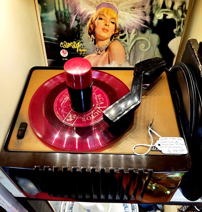 That red vinyl record spinning atop this vintage player isn't just music—it's a portal to sock hops and soda fountains.