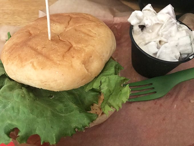A sandwich that demands both hands and your full attention. Fresh lettuce peeks out like it's trying to escape, but trust me—you'll want every component in each bite.