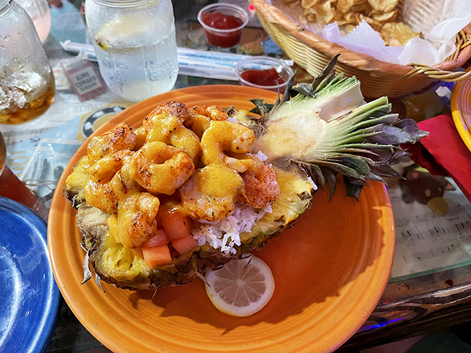 Tropical paradise on a plate—shrimp nestled in a hollowed pineapple boat, sailing straight to your taste buds.