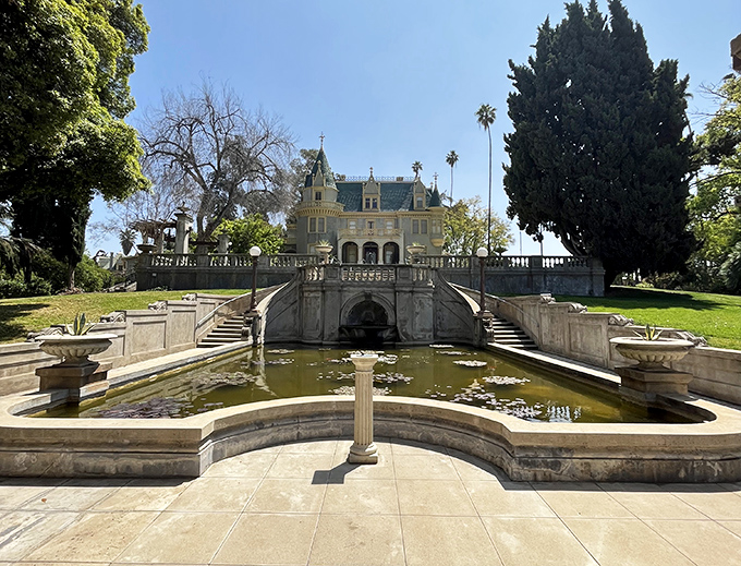 Water, stone, and that magnificent mansion—a view that makes you wonder if you've accidentally stepped through a portal to a European estate.