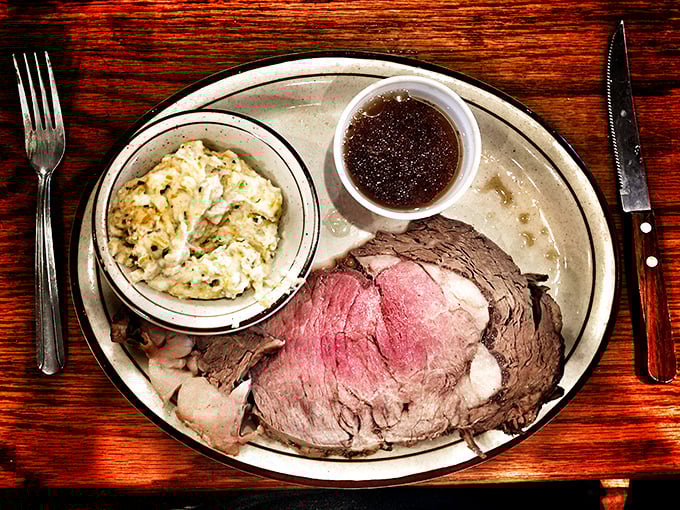 The prime rib that launched a thousand road trips. Perfectly pink, accompanied by creamy potato salad and that essential jus—this is meat meditation at its finest.
