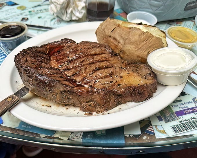 This steak isn't just resting on the plate—it's posing for its glamour shot. The grill marks are like nature's way of saying "you're welcome."