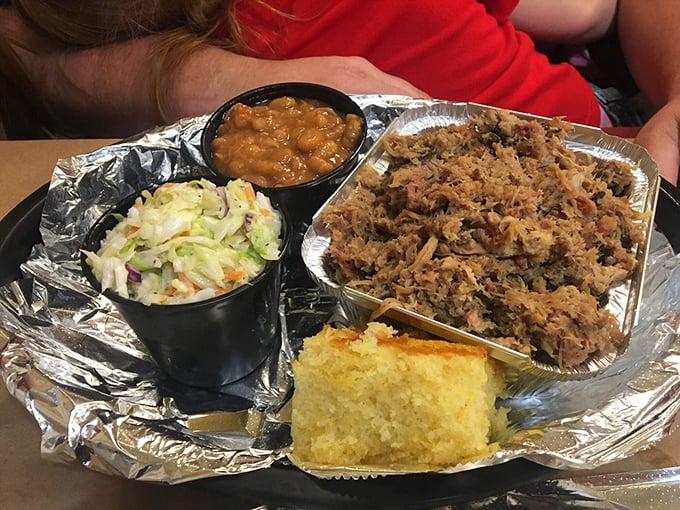 This pulled pork platter isn't just food—it's edible evidence that good things come to those who smoke low and slow. The sides aren't afterthoughts; they're co-stars.