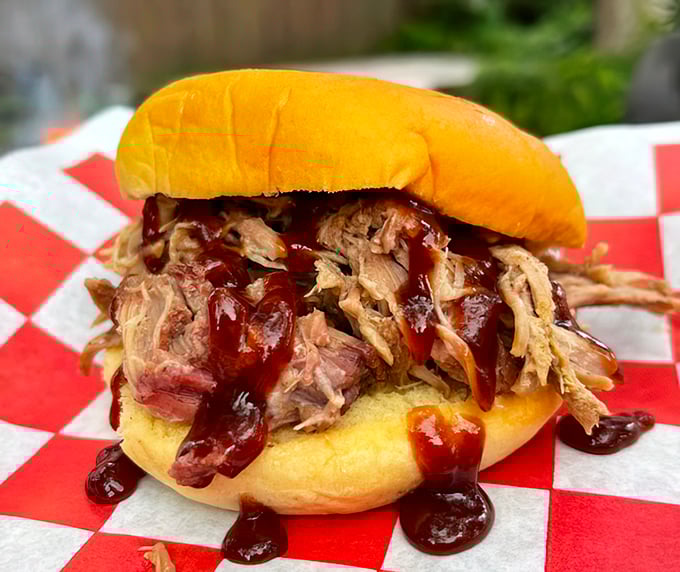 The pulled pork sandwich – where smoke-kissed strands of pork meet pillowy bun in a relationship sealed with tangy barbecue sauce.