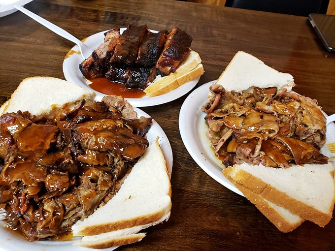 Three pulled pork sandwiches that showcase Memphis barbecue artistry. The bread knows its role – supporting the star without stealing the spotlight.
