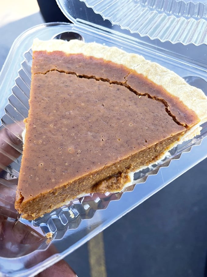 This slice of pumpkin perfection isn't just pie—it's portable nostalgia, packaged in a convenient to-go container for roadtrip emergencies.