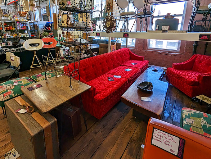 That crimson velvet couch isn't just furniture—it's a time machine to an era when living rooms made bold statements and comfort came in technicolor.